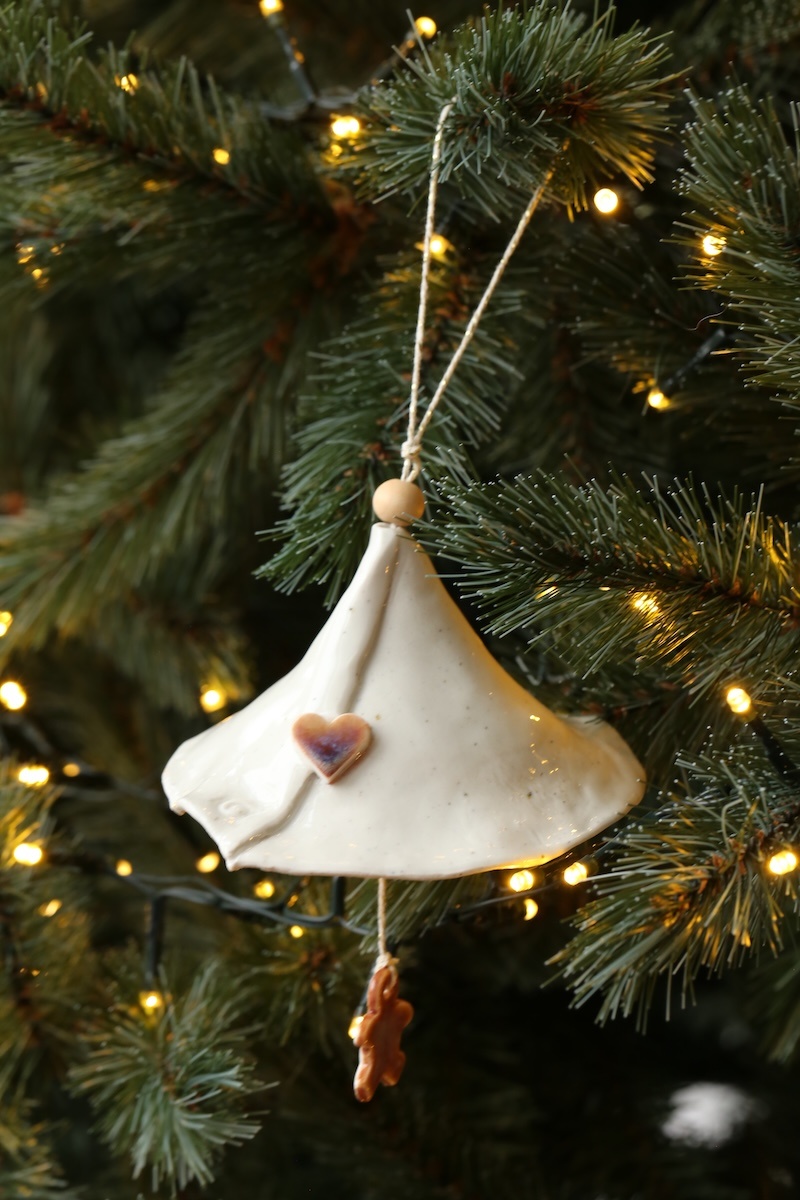 Handmade porcelain Christmas bell decorated with a Christmas figurine ...