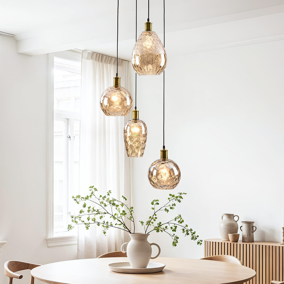 Design hanglamp Nilo – 4-lichts amber glas met bolling - LumenXL.nl